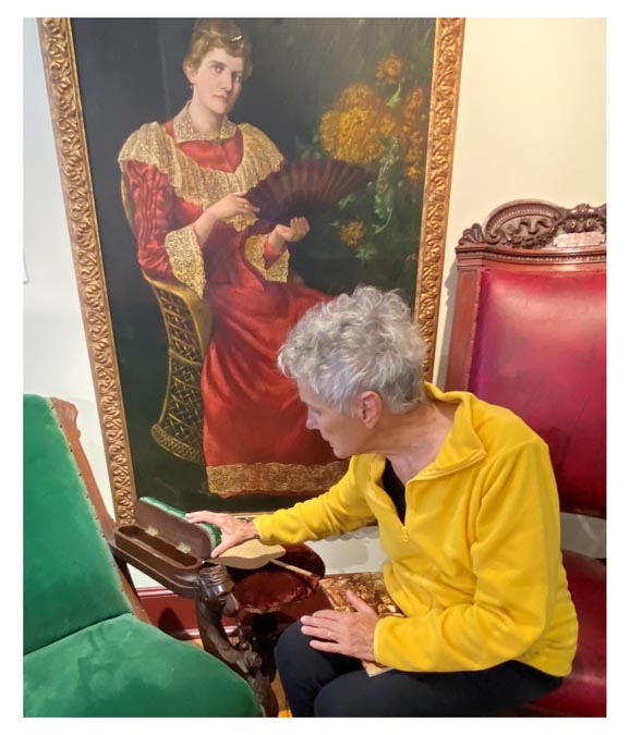 Mary Clark Ormond, president of the Aurora Historical Society, examines ...